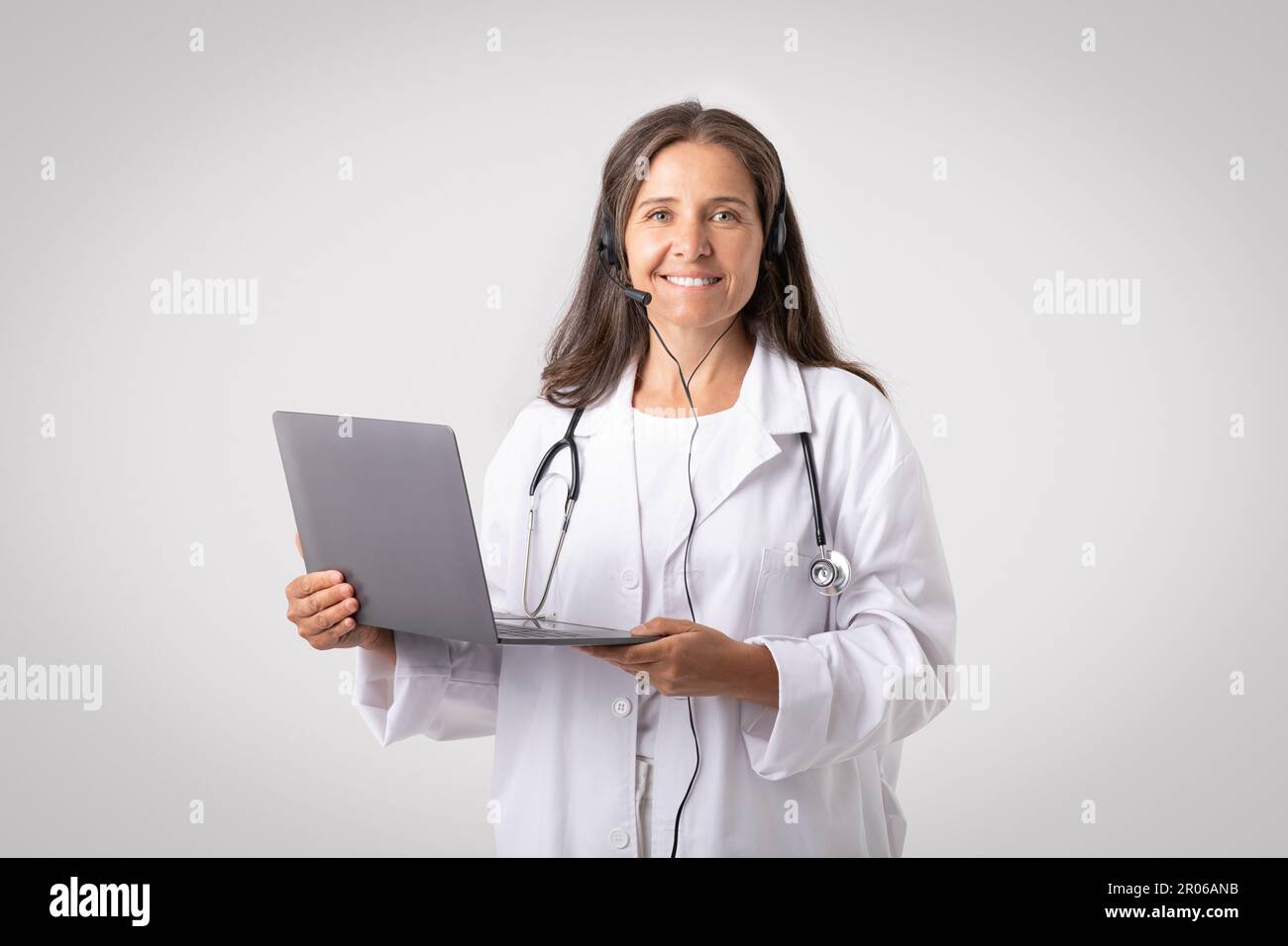 Telemedicine consultations. Senior woman doctor conducting remote ...