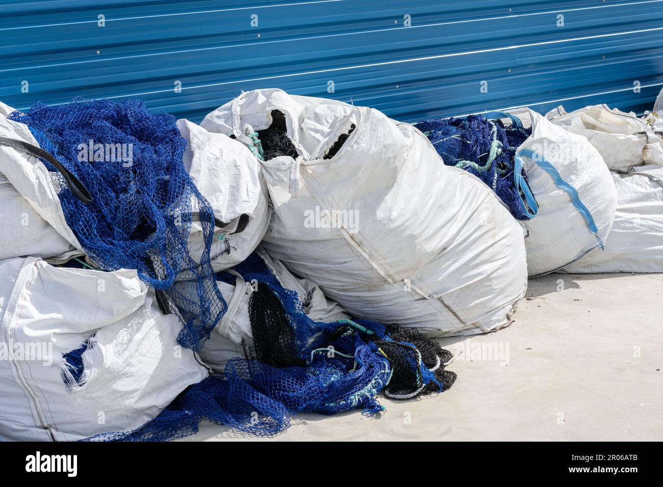 Used fishing net on sacks waiting to be recycled. Fishing industry ...