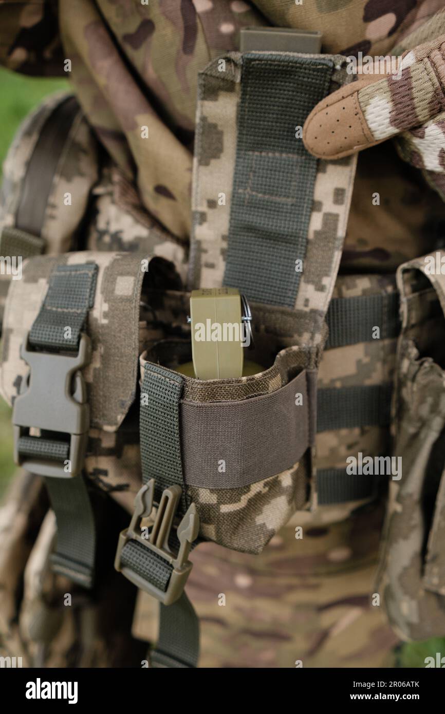 Preparing for Combat: Close-up of Soldier Putting on Gear in the Field ...