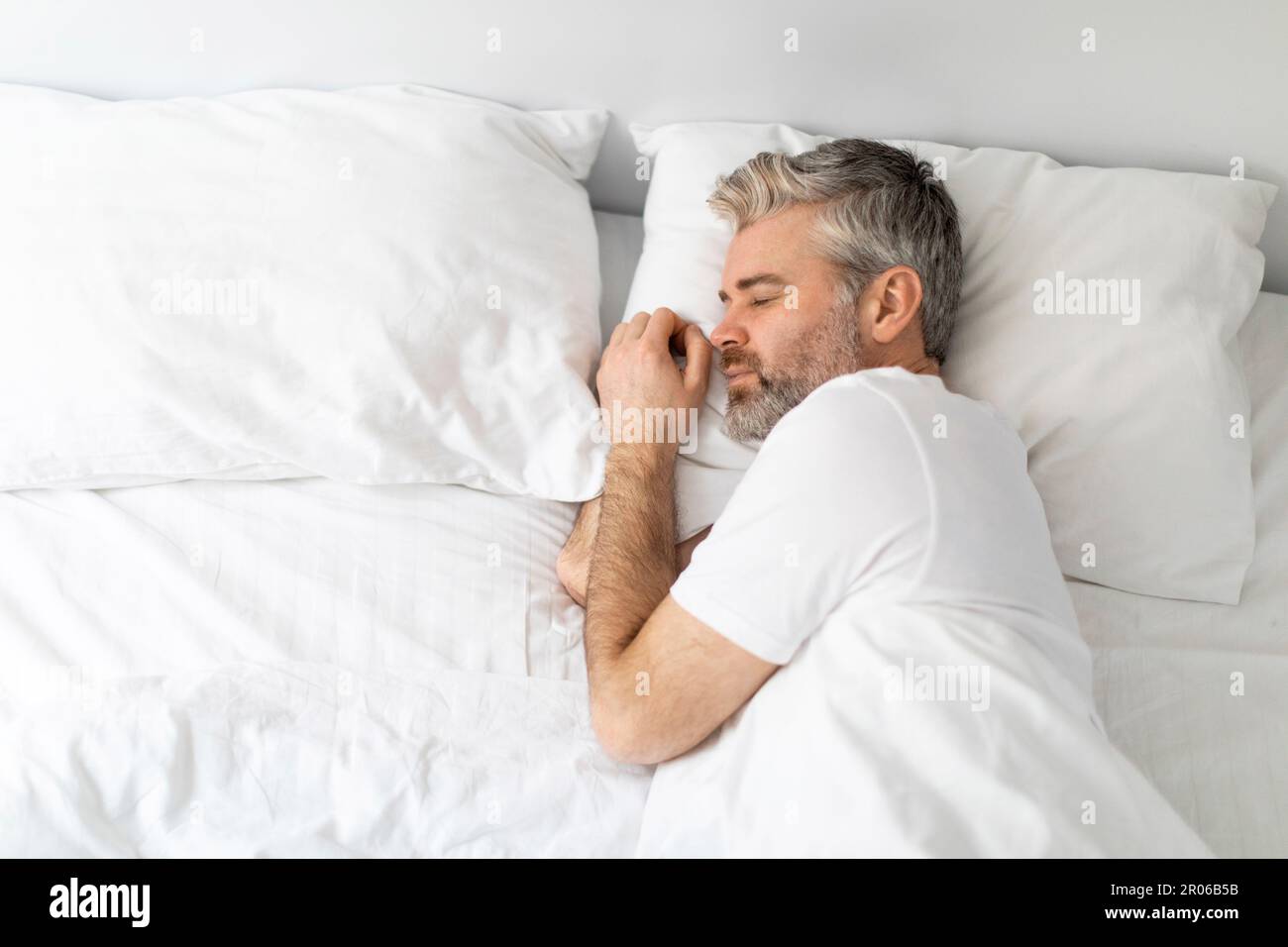 Top view of middle aged man sleeping alone in bed Stock Photo - Alamy