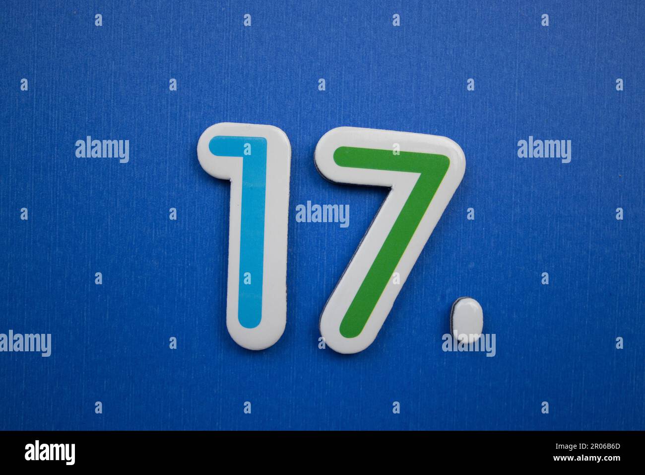 The number 17 is placed on a blue background, photographed from above ...