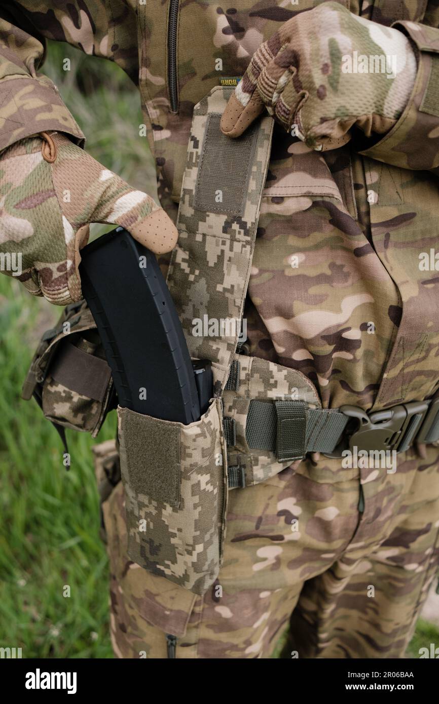 Preparing for Combat: Close-up of Soldier Putting on Gear in the Field ...