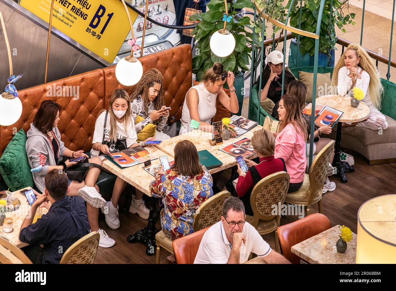 Customers in busy basement coffee shop, Vincom Centre, Ho Chi Minh City ...