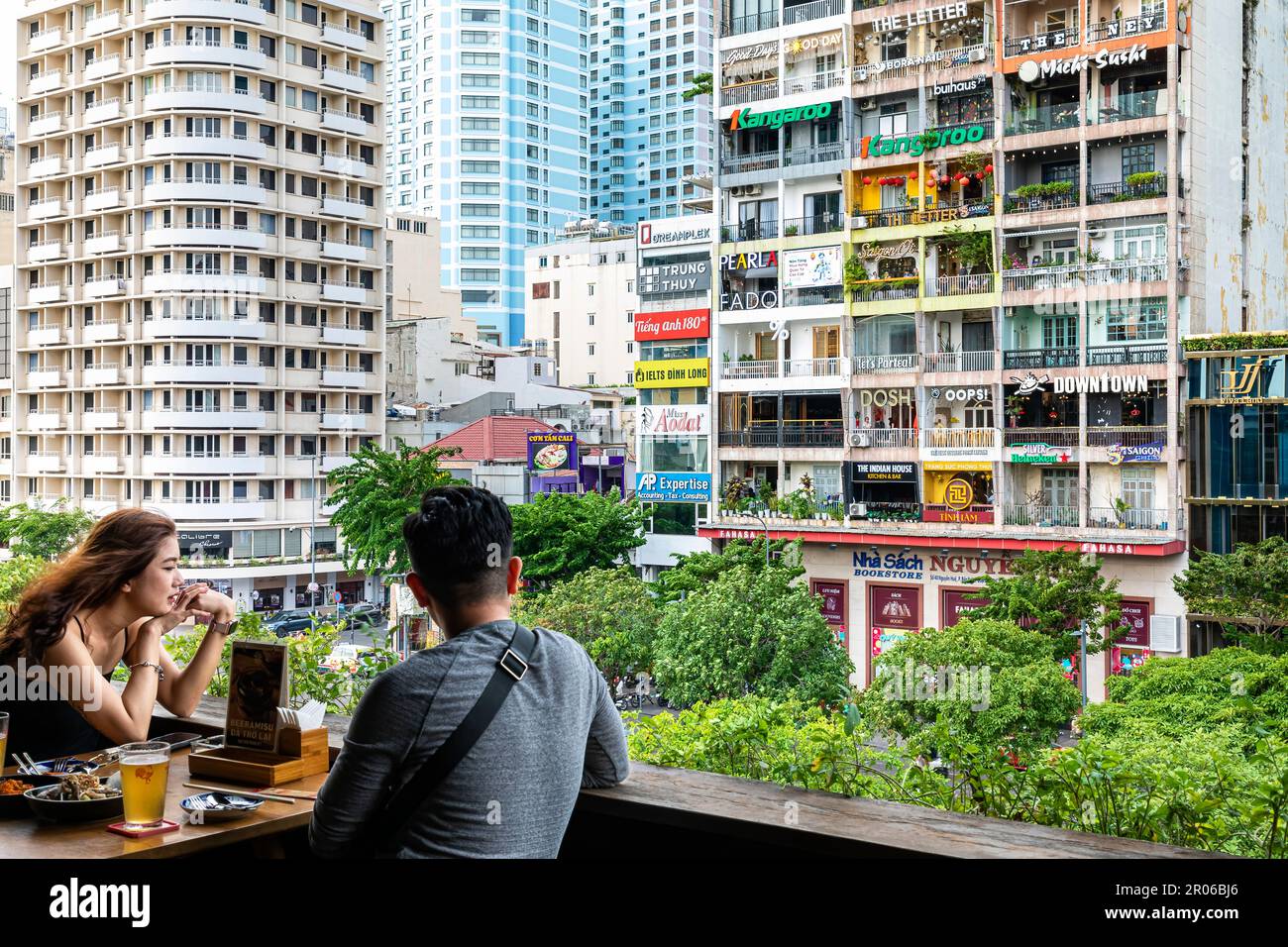 Vietnamese couple sitting at restaurant overlooking Nguyen Hue Walking ...