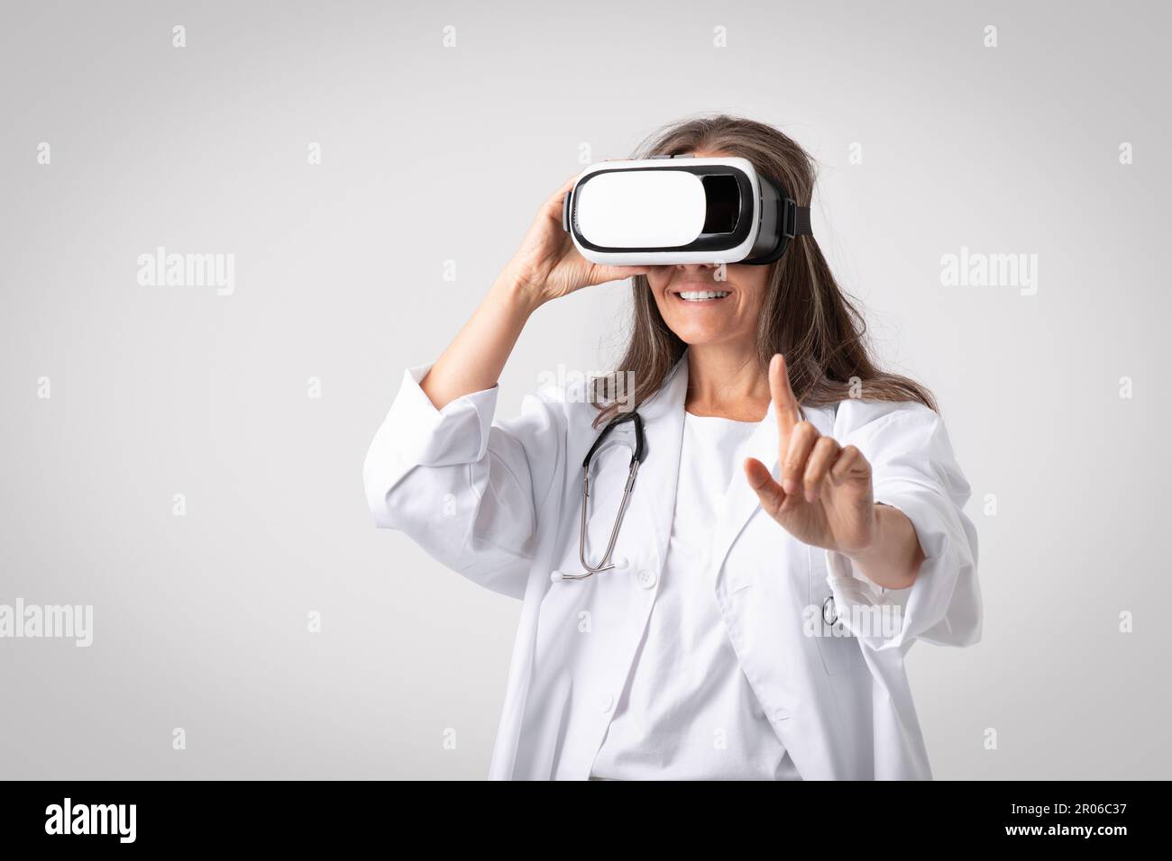 VR medicine concept. Senior woman doctor using modern virtual reality ...