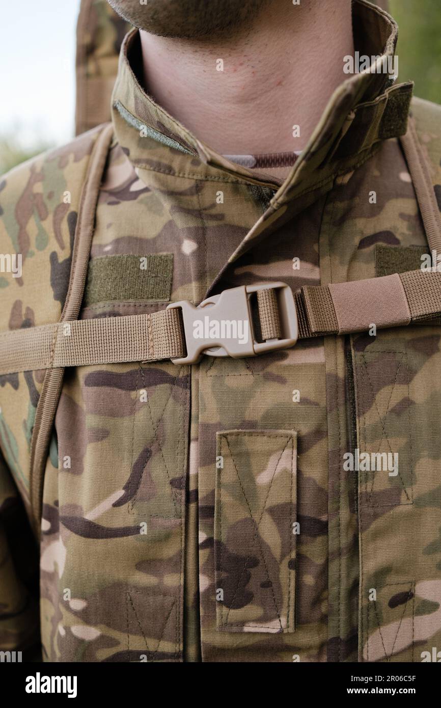 Preparing for Combat: Close-up of Soldier Putting on Gear in the Field Stock Photo - Alamy