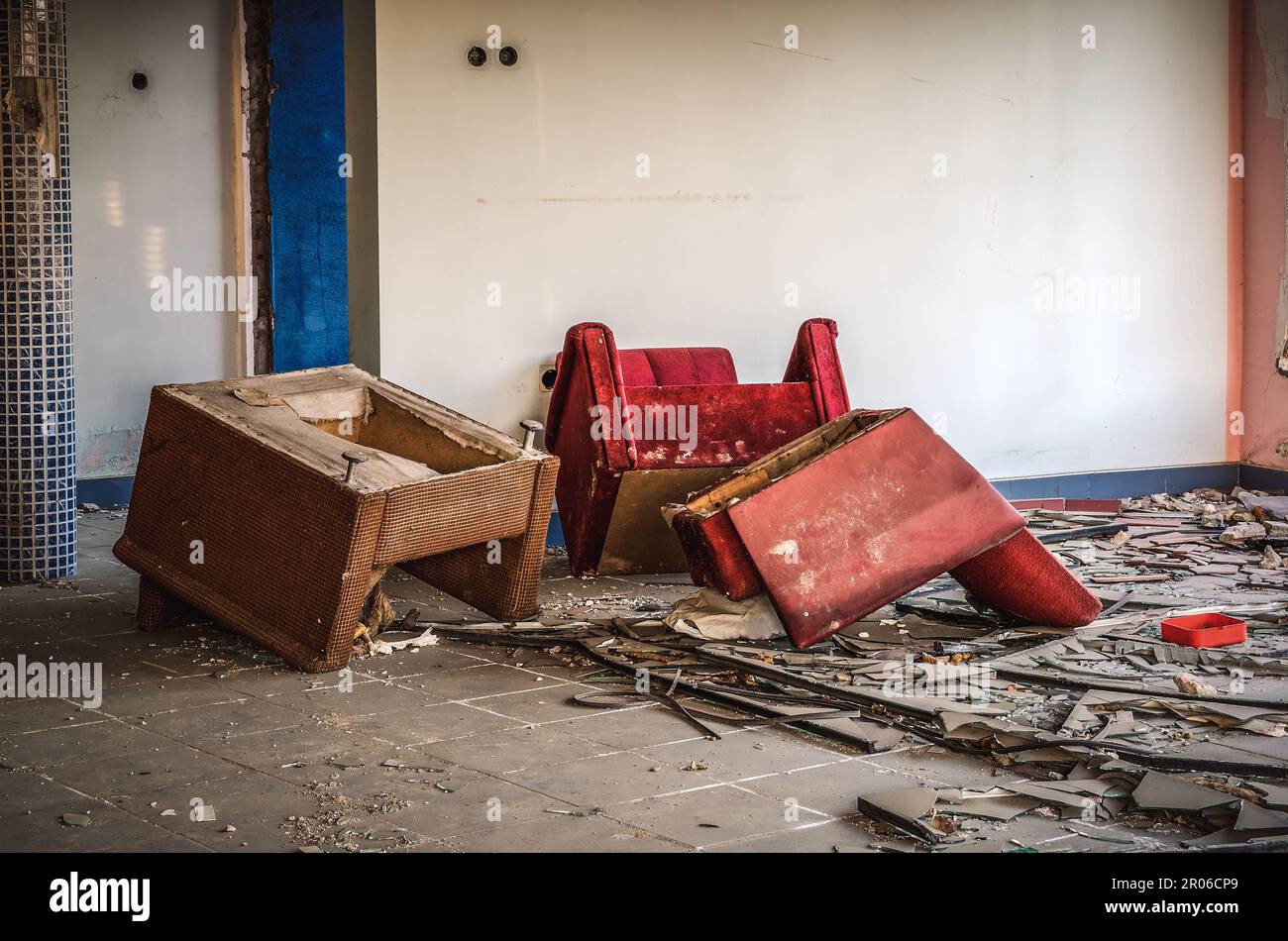 Interior of an old abandoned and destroyed house. Old chairs and rubble ...
