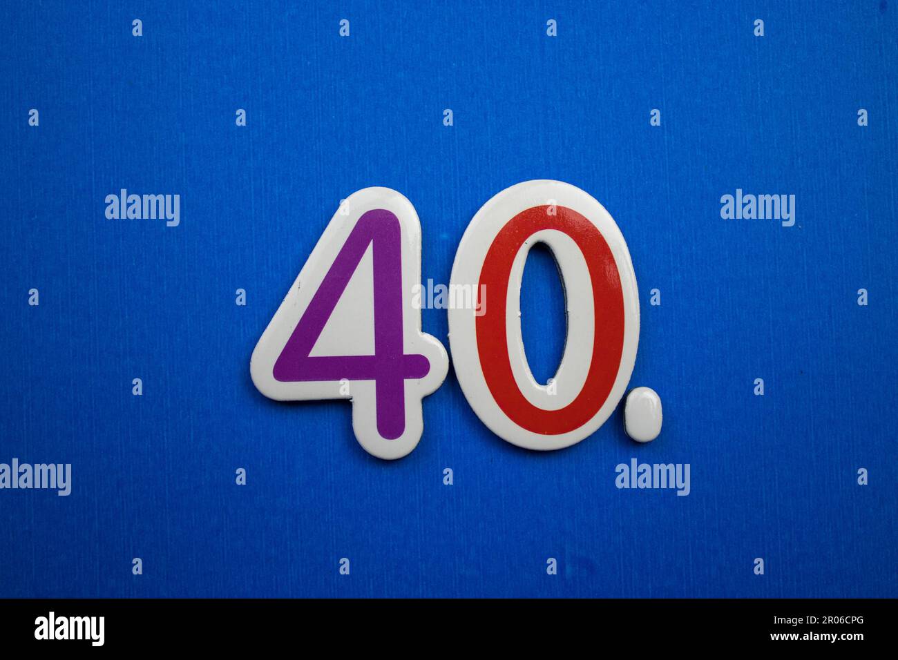 The number 40, placed on a blue background, photographed from above ...