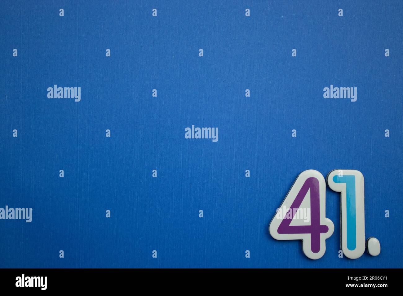 The number 41, photographed from above, purple and light blue, placed ...