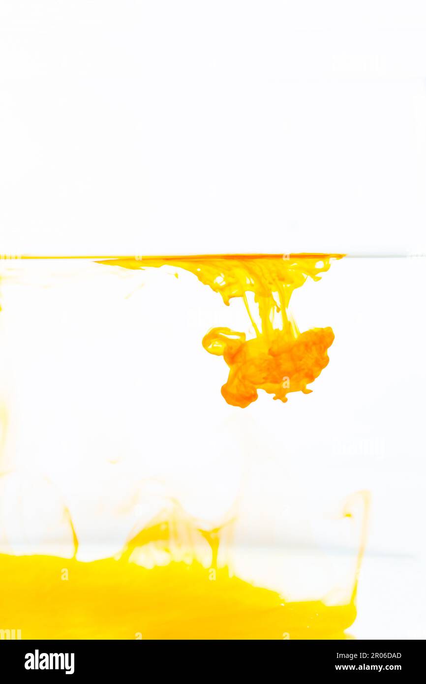 Orange ink drop in water, abstract orange ink in water on white ...