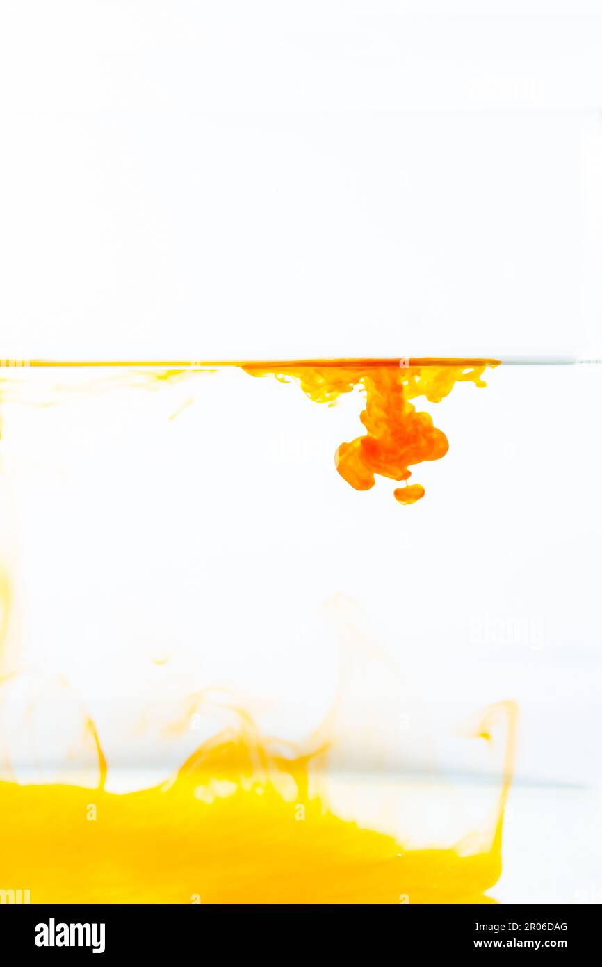 Orange ink drop in water, abstract orange ink in water on white ...