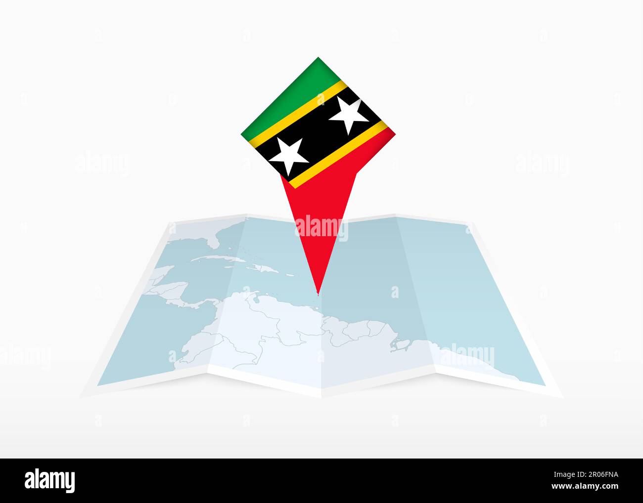 Saint Kitts and Nevis is depicted on a folded paper map and pinned ...