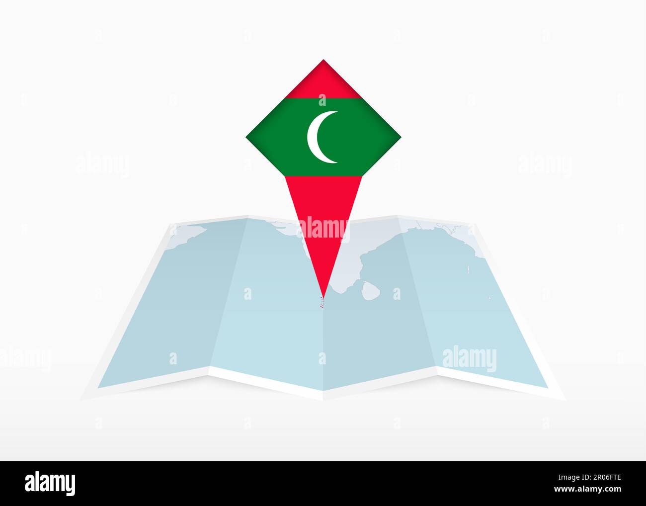 Maldives is depicted on a folded paper map and pinned location marker ...