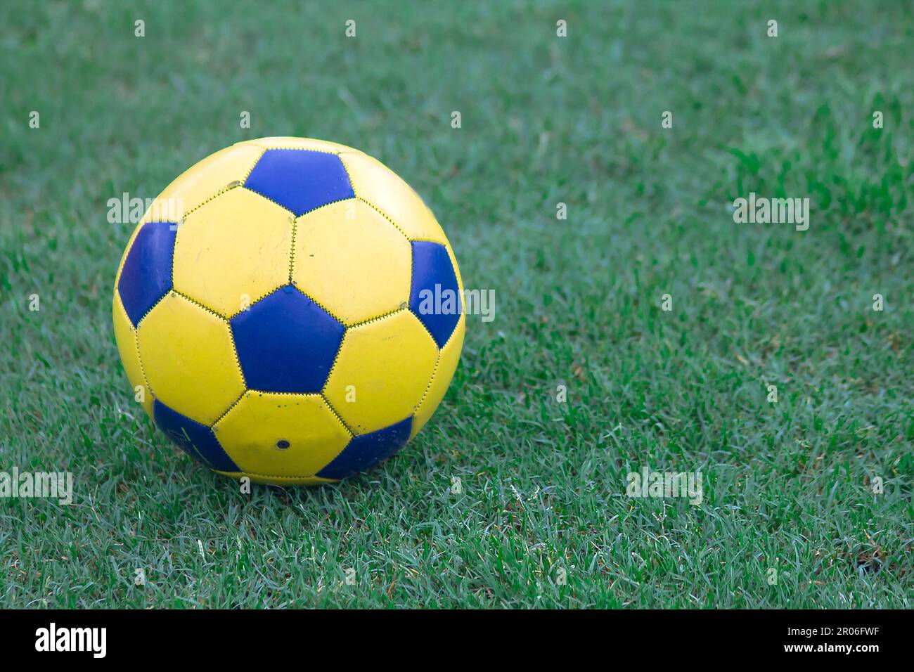 Yellow soccer ball on the lawn Stock Photo - Alamy