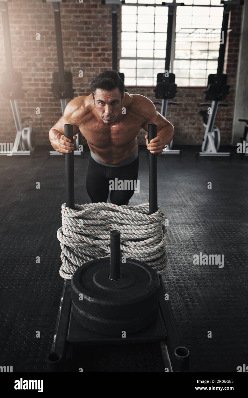 The battle is only against yourself. a muscular young man pushing a ...