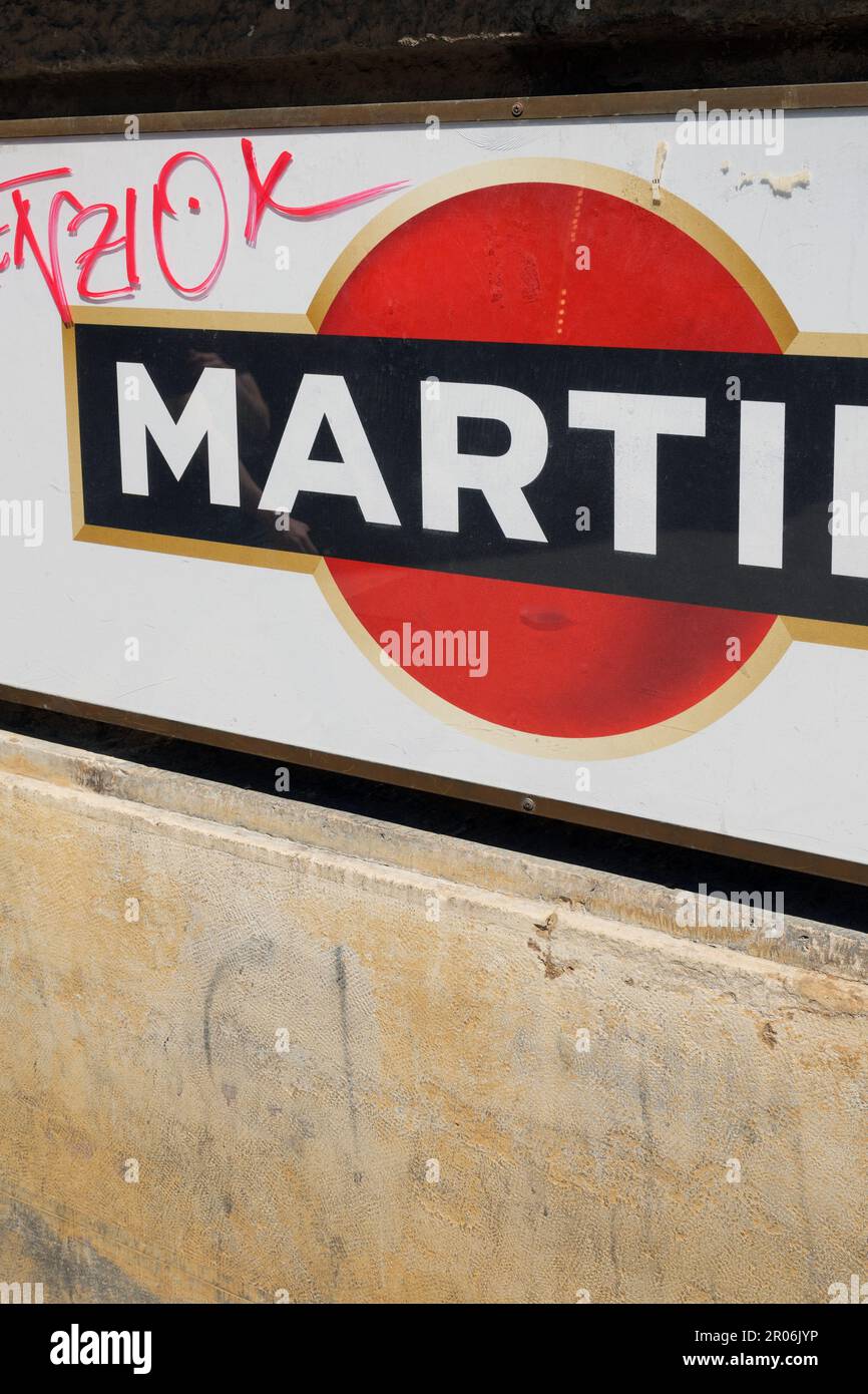 Martini italian spirit logo in a street billboard with some graffiti on ...
