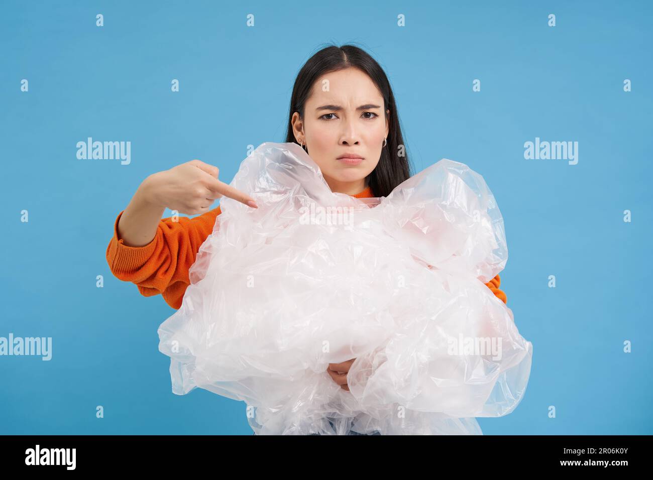 Angry eco-activist points at big pile of plastic bags, fighting to save ...