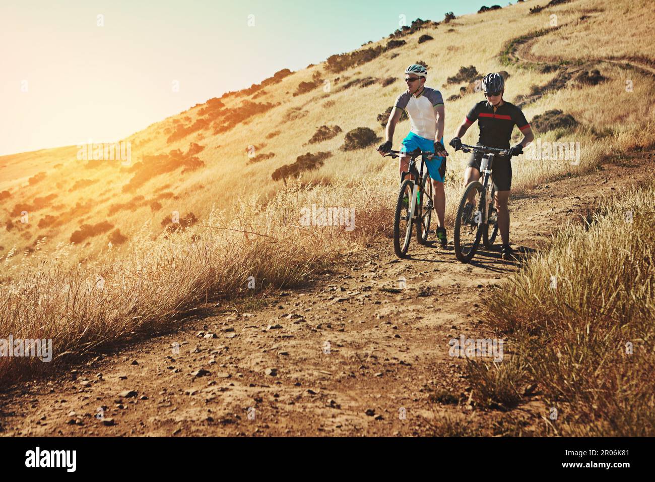 Explore the outdoors while having fun. two cyclists out cycling in the ...