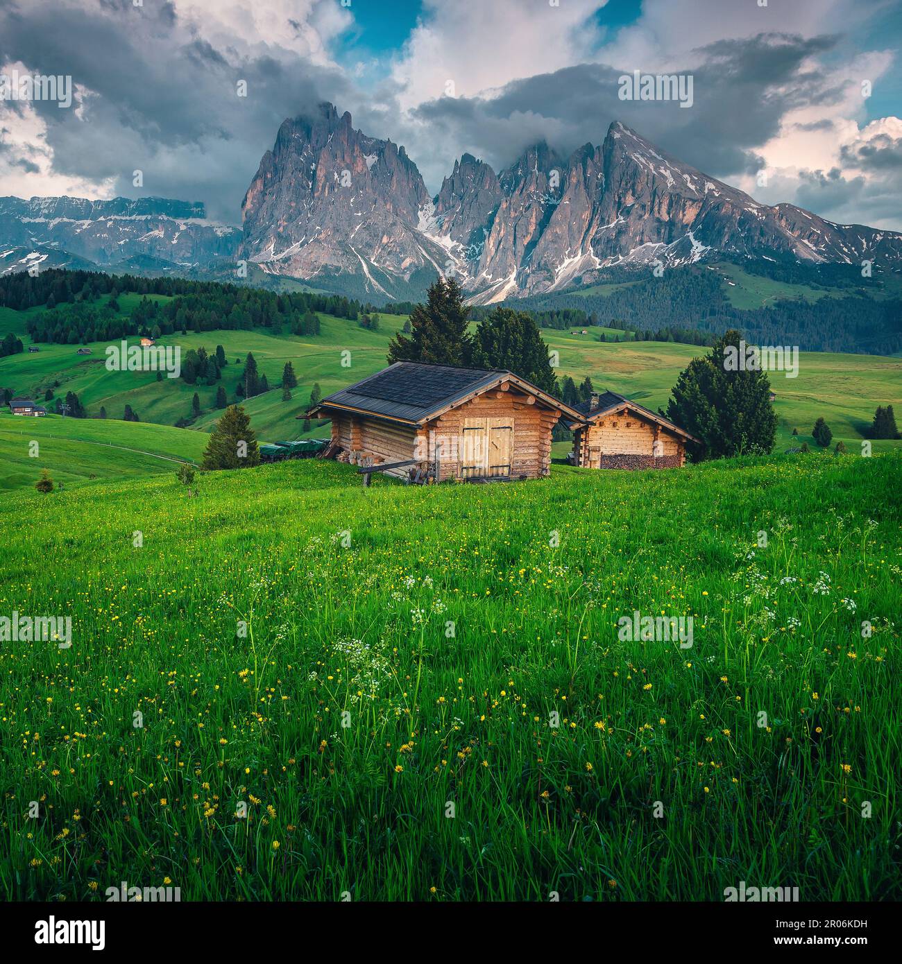 Fantastic summer alpine resort with log huts on the green flowery ...