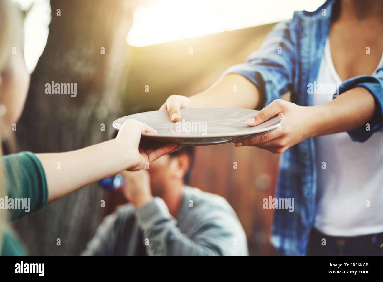 Sharing more than meals together. two unrecognizable women passing an ...