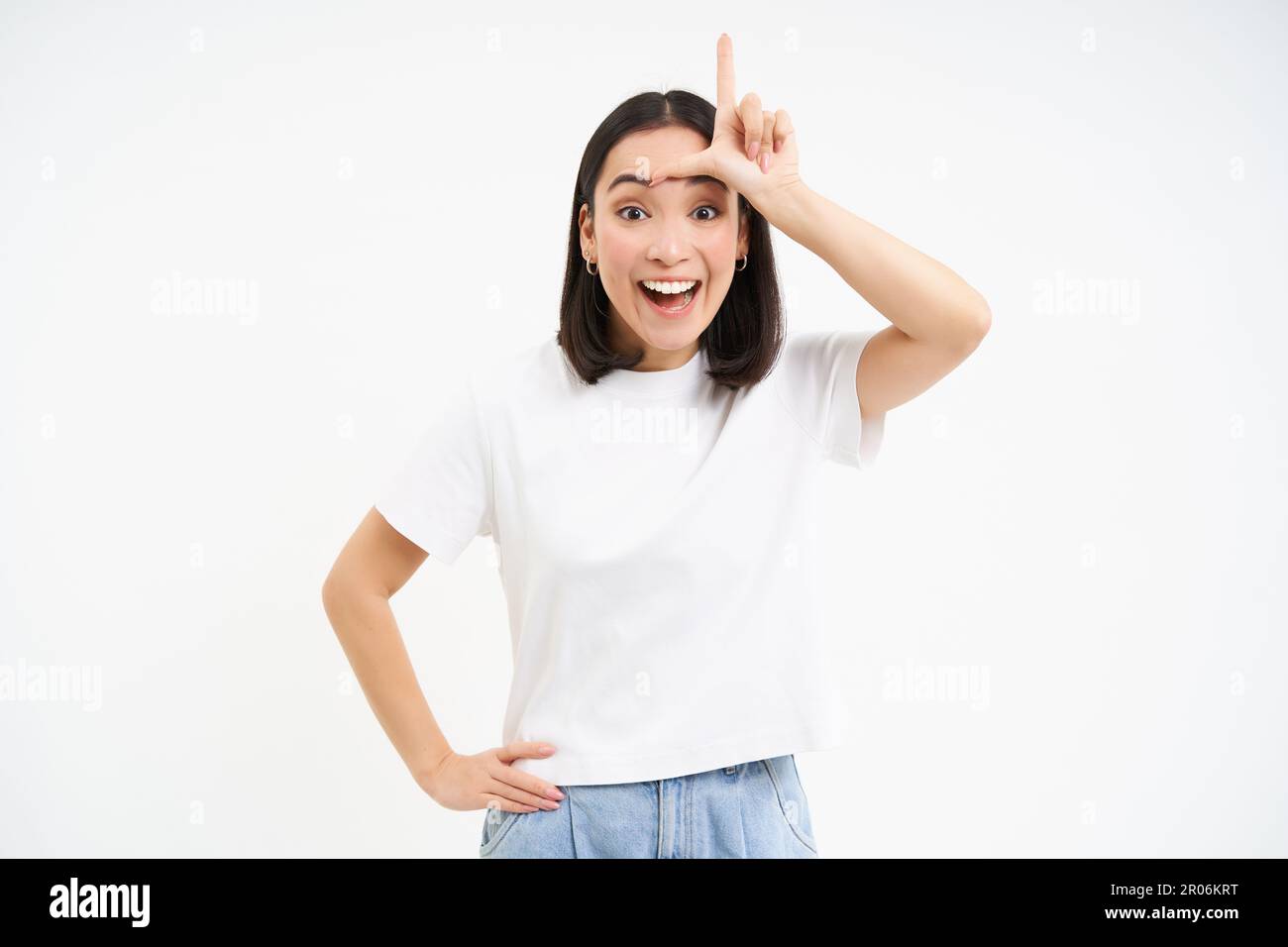 young woman shows L letter, loser gesture on forehead, mocking someone ... young woman shows L letter, loser gesture on forehead, mocking someone ...