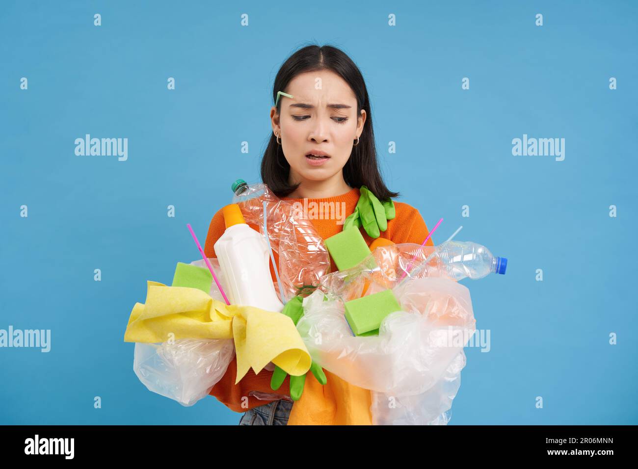 Sad asian female student, holds recycling waste, collects plastic ...