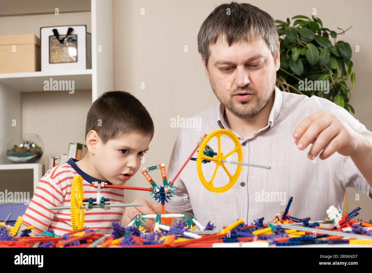 Dad and son build figures from the constructor. Spending time together ...