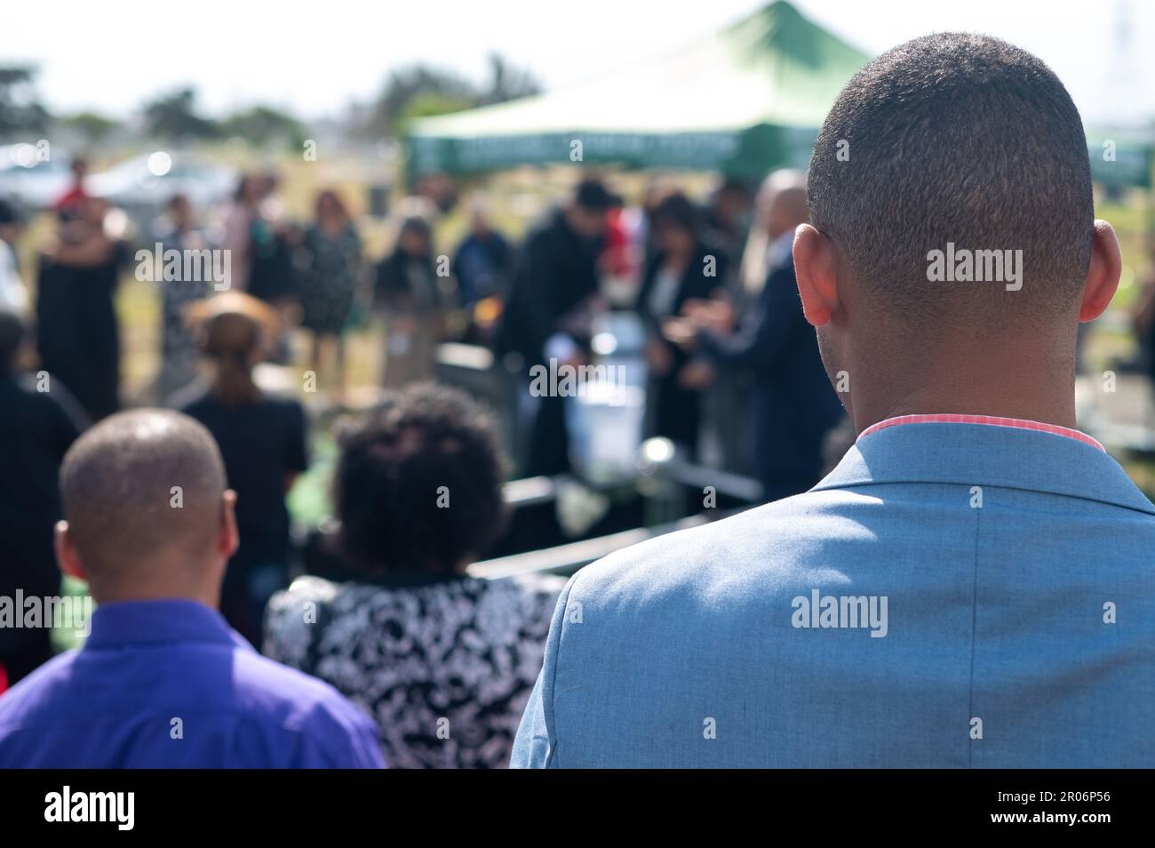 People seen at funeral service with blurred background Stock Photo - Alamy