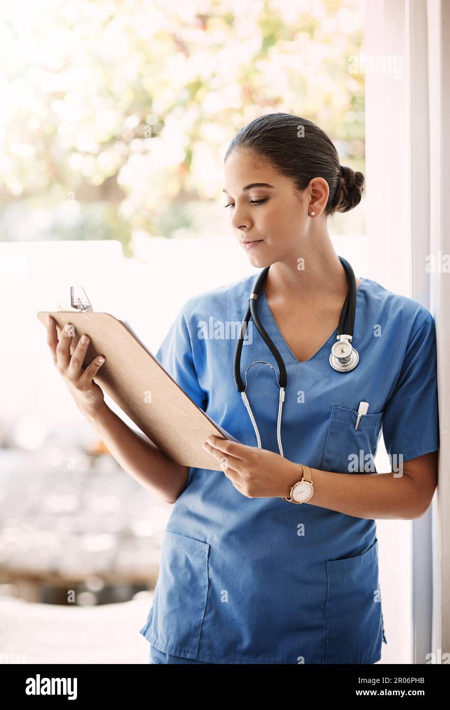 Checking your records. an attractive young female medical practitioner ...