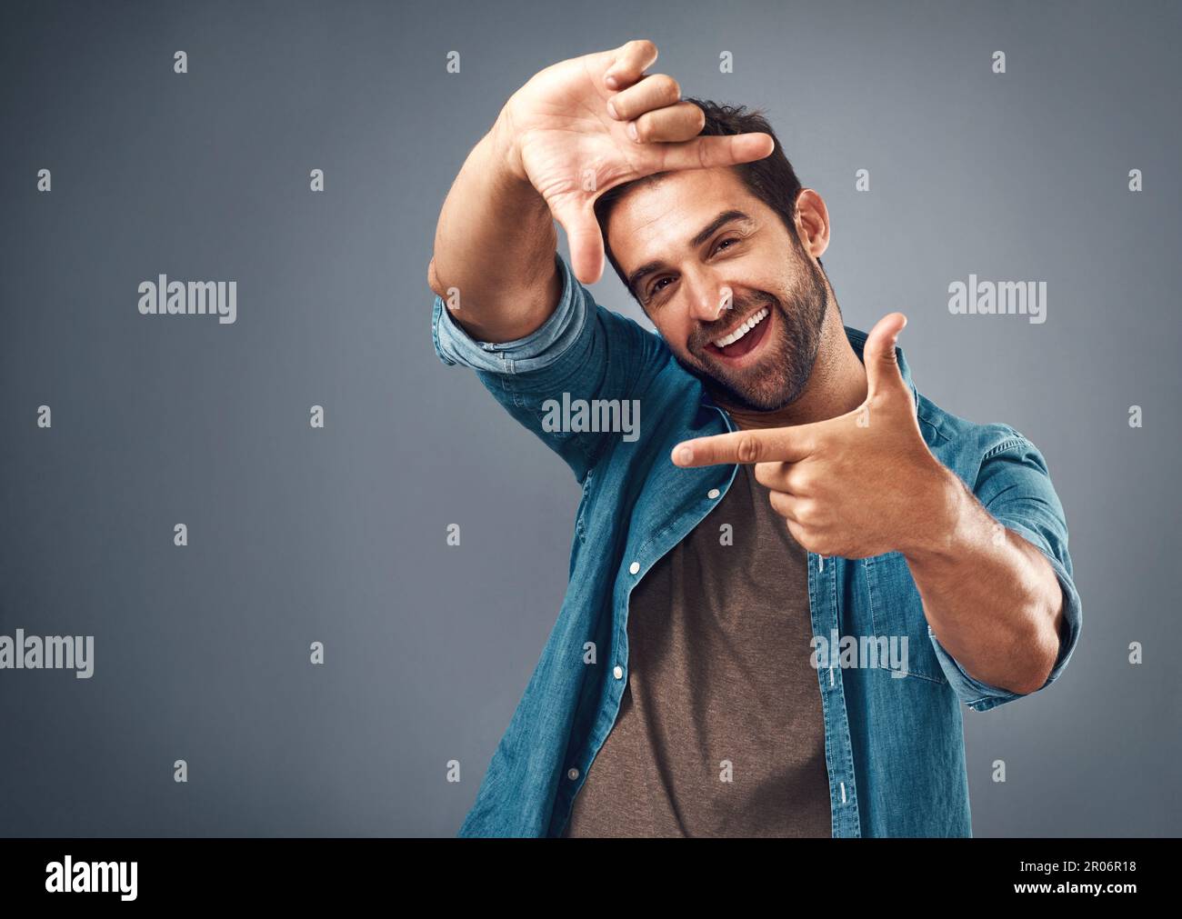 Youre a natural. Studio portrait of a handsome young man making a ...