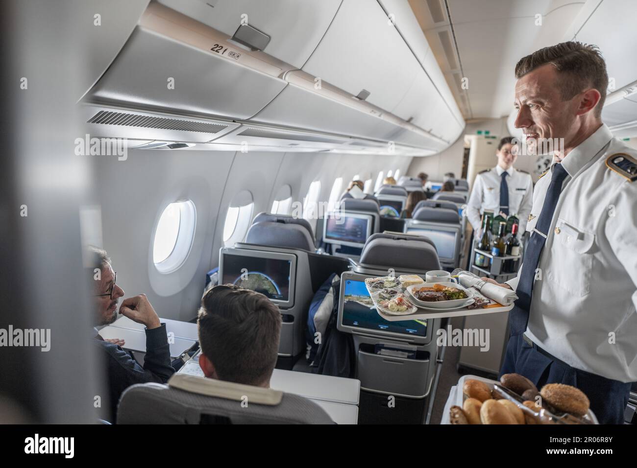 FILED - 04 May 2023, Brandenburg, Schönefeld: A flight attendant serves ...