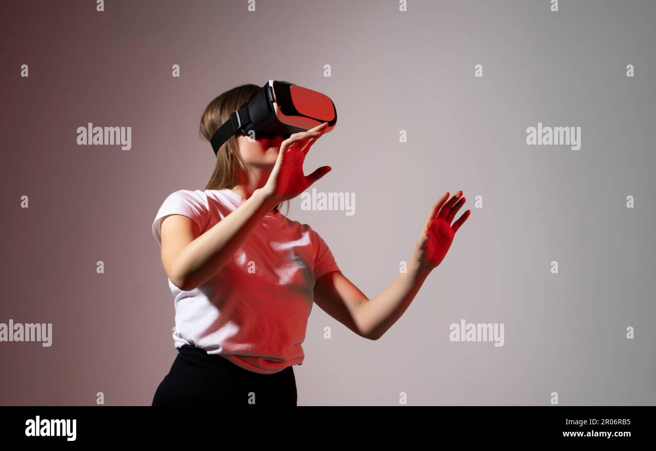 Woman enjoying a VR experience. Woman with VR headset touching ...