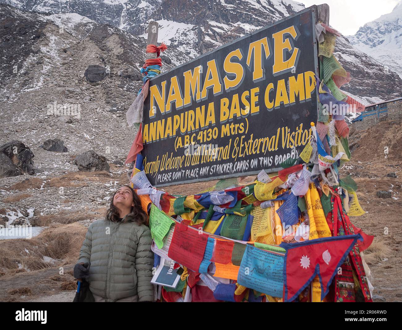 Female backpacker thrilled at Annapurna Base camp board Stock Photo - Alamy