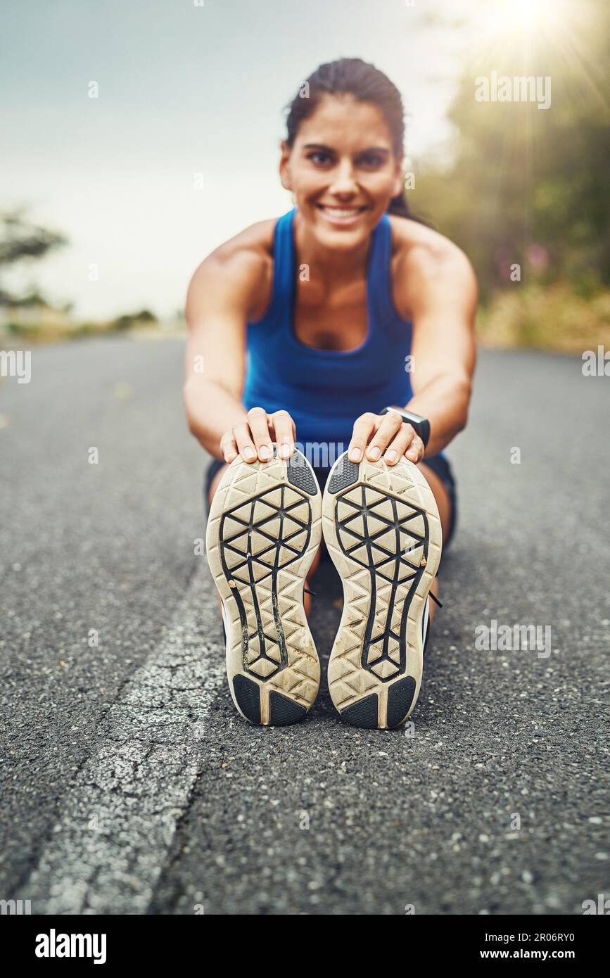 Long and lean, strong and keen. a young beautiful woman training for a ...