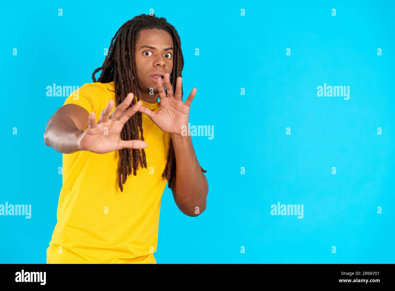 Latin man with dreadlocks gesturing with the hands in fear Stock Photo ...