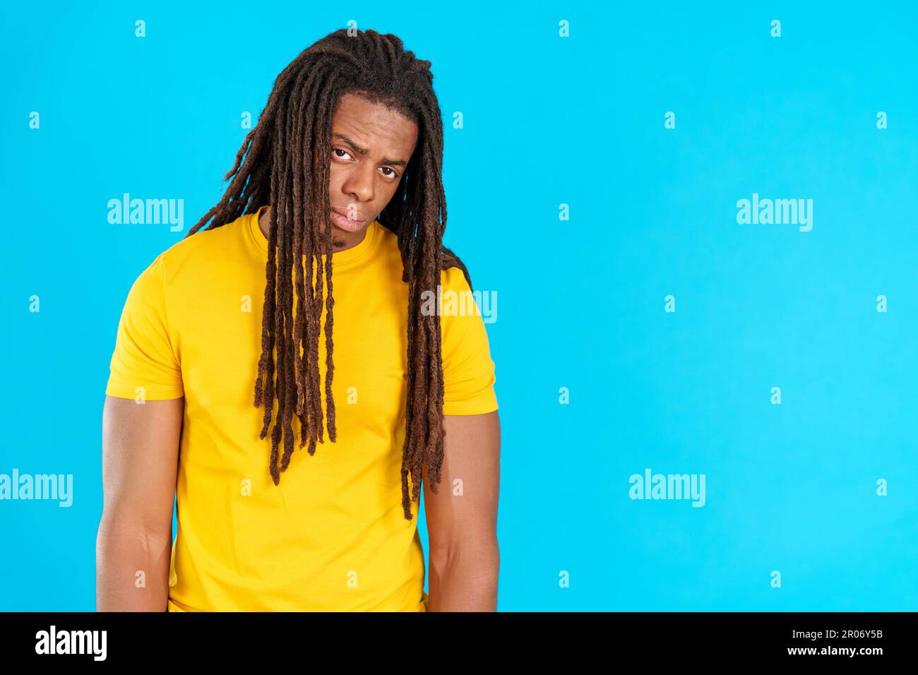 Sad latin man with dreadlocks looking at camera Stock Photo - Alamy