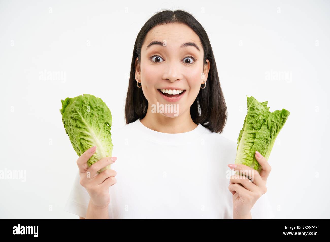 Happy korean woman vegetarian, smiling and showing cabbage, eating ...