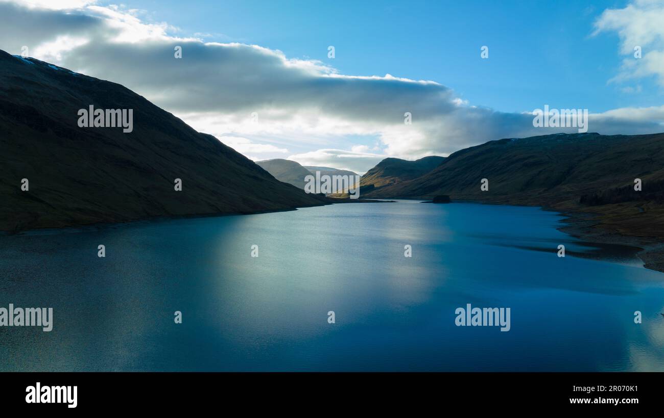 wonderful lake and sky view. Blue lake among the mountains and clouds ...