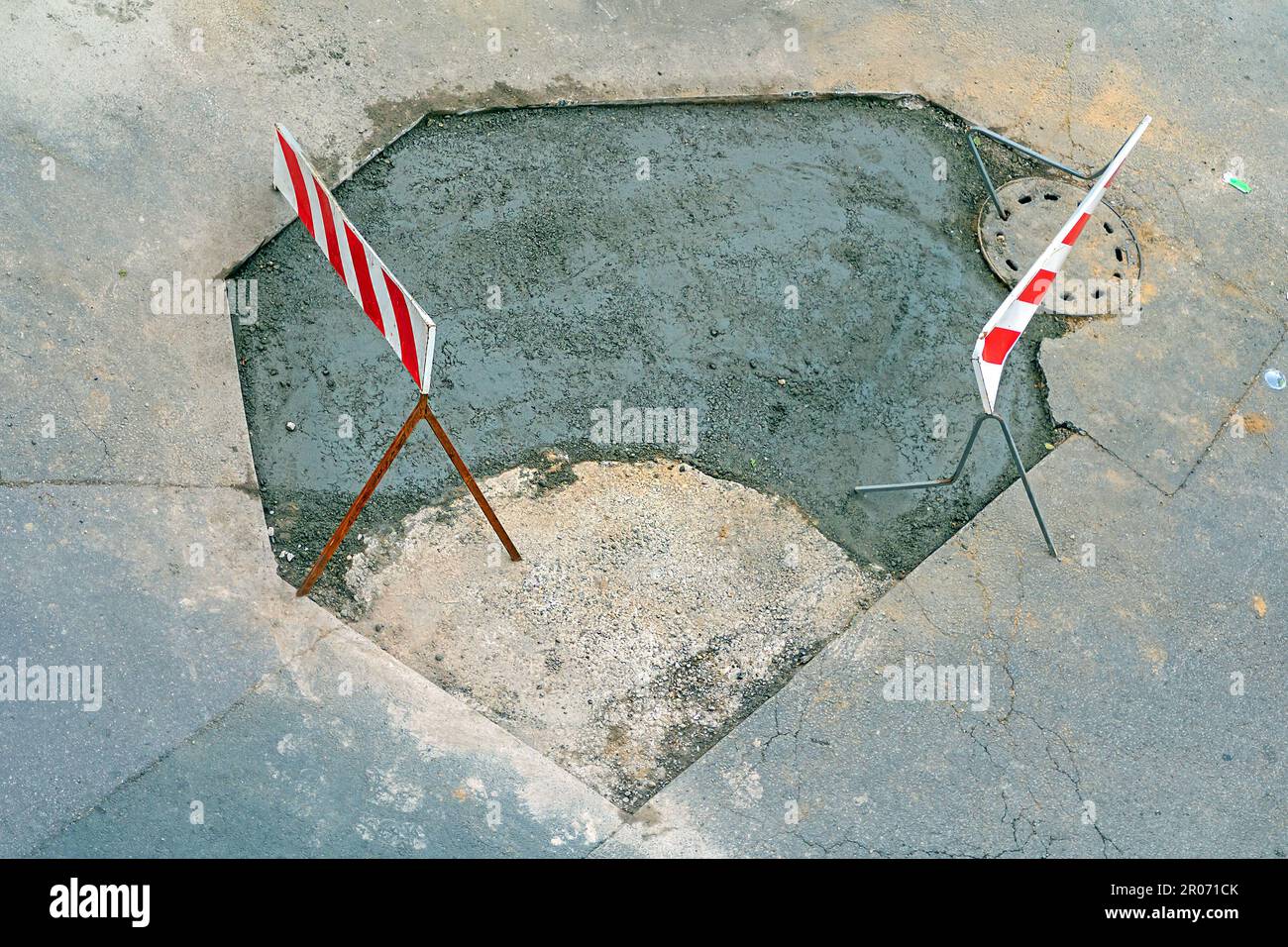 Patched up repaired hole on the urban street road Stock Photo - Alamy