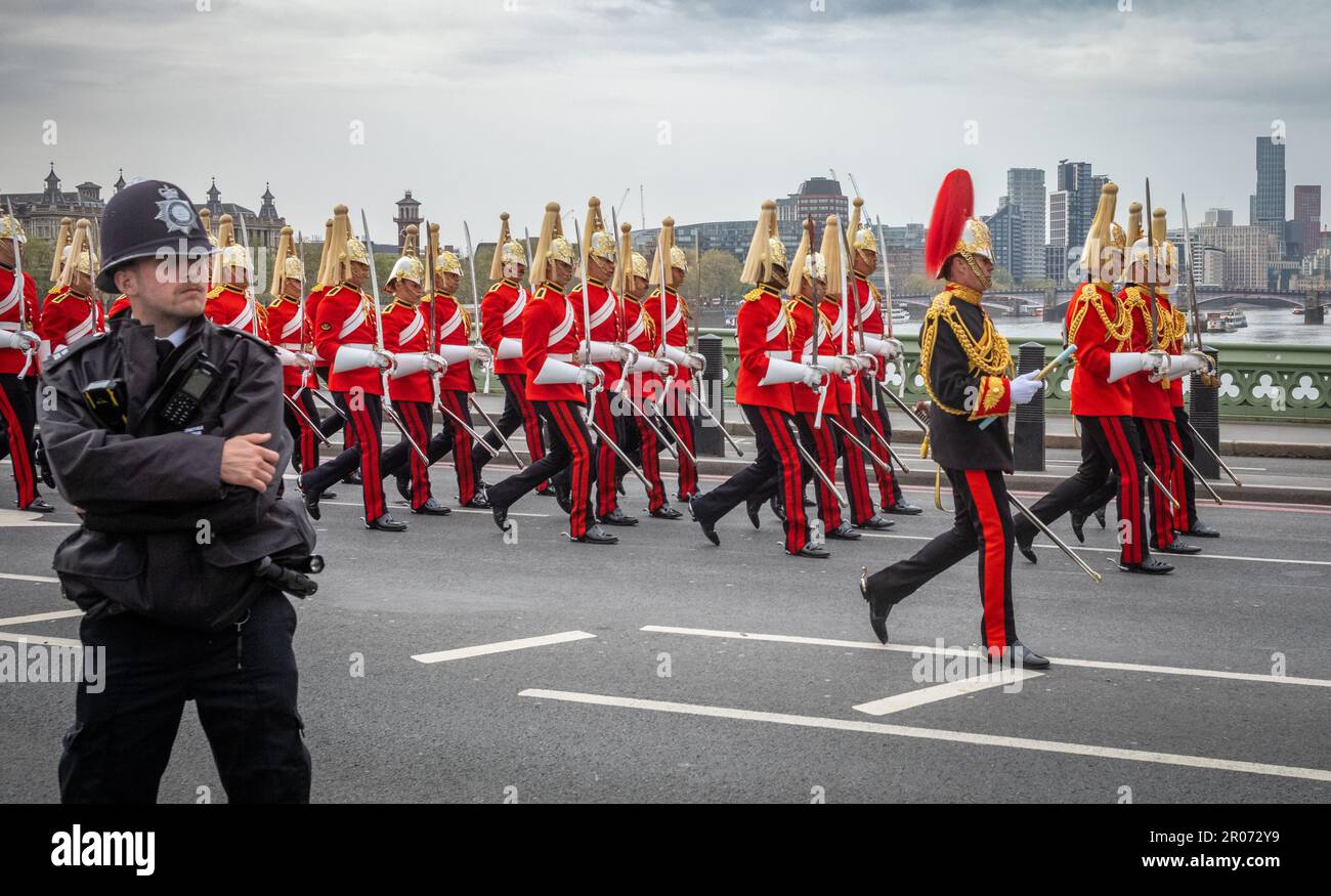 A policeman stands guard as soldiers from the British Army's Household ...