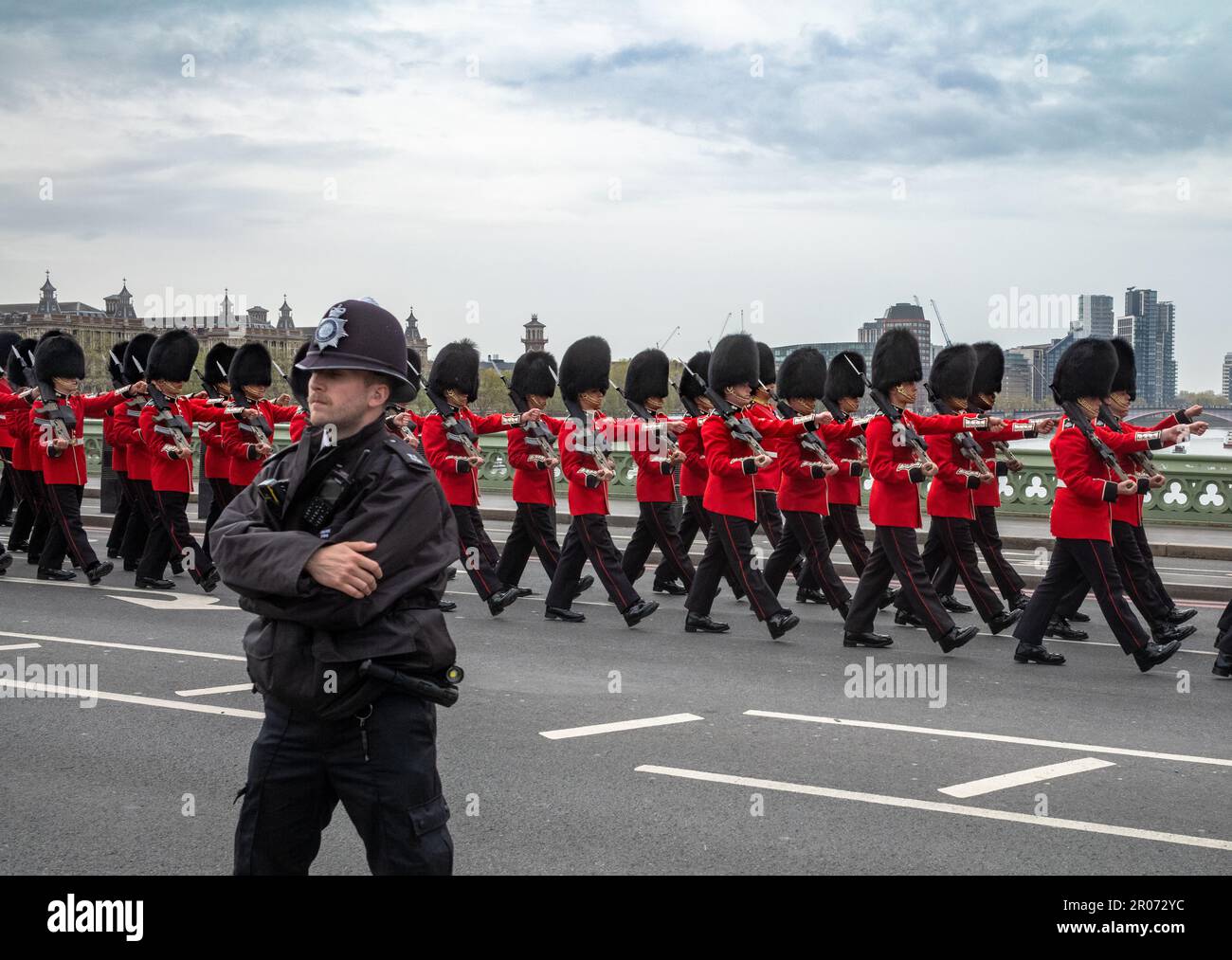 A policeman stands guard as soldiers from the British Army's Grenadier ...