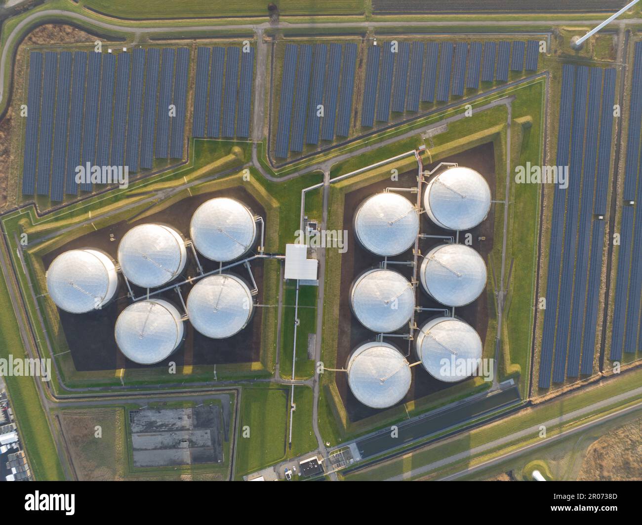 Oil reserve storage units and solar panels Stock Photo - Alamy
