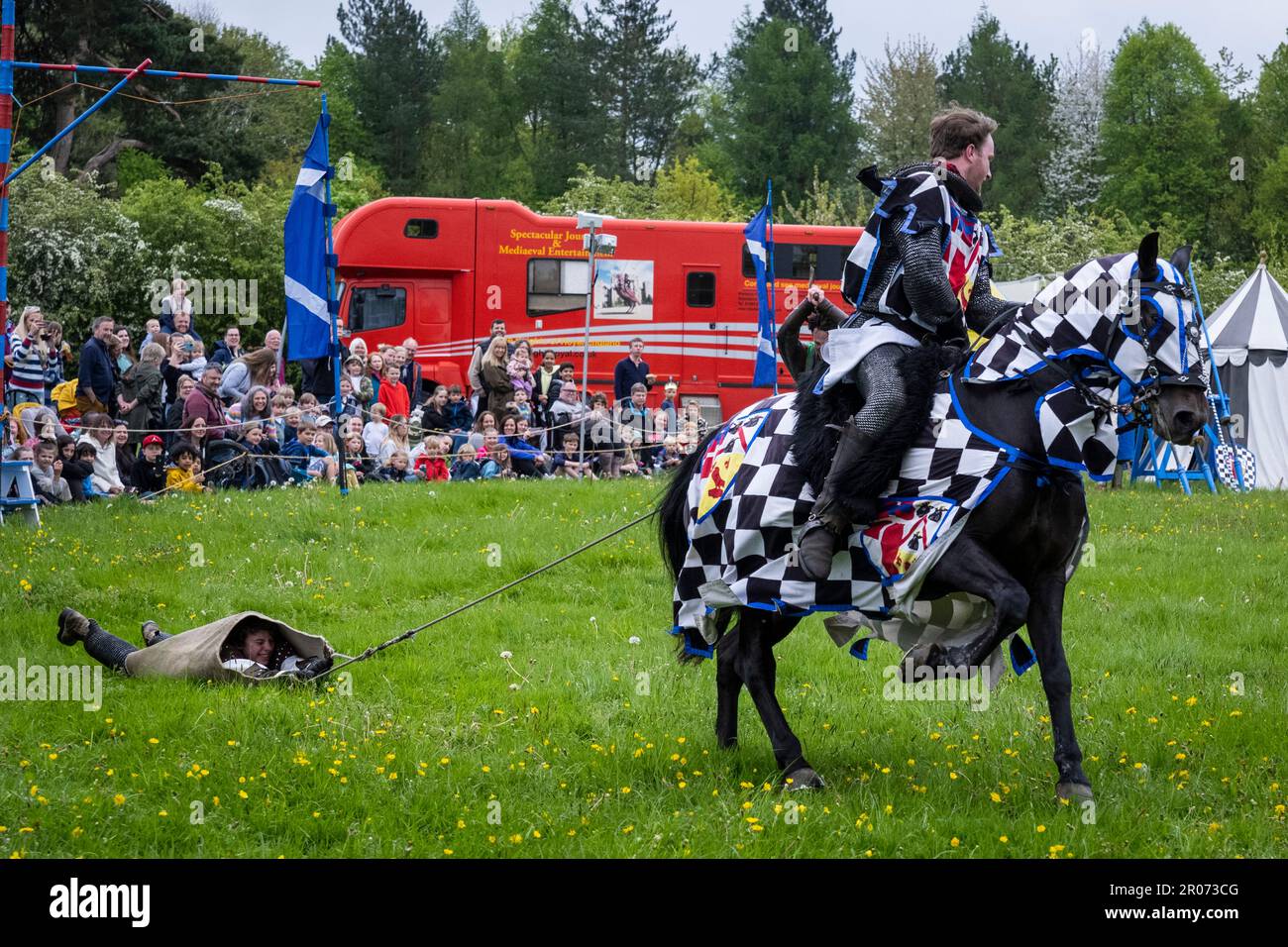 Chalfont, UK. 7 May 2023. A re enactor as an armoured knight punishes ...
