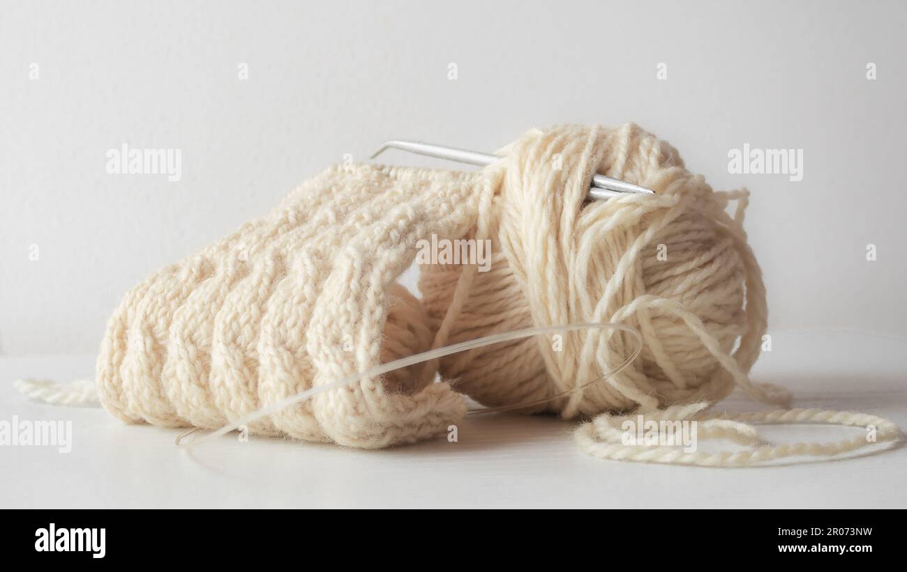A closeup of a yarn of beige thread on a white background Stock Photo ...