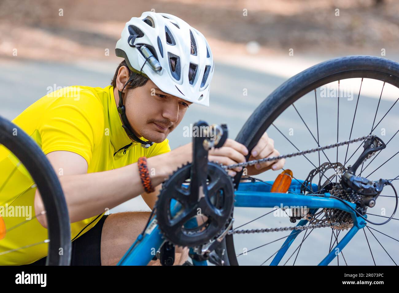 Male racer checking gear condition during a short break. Timely ...