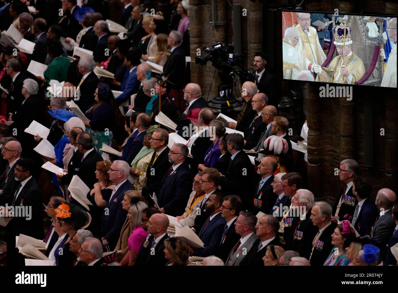 King Charles III wears the St Edward's Crown as he is projected on a ...