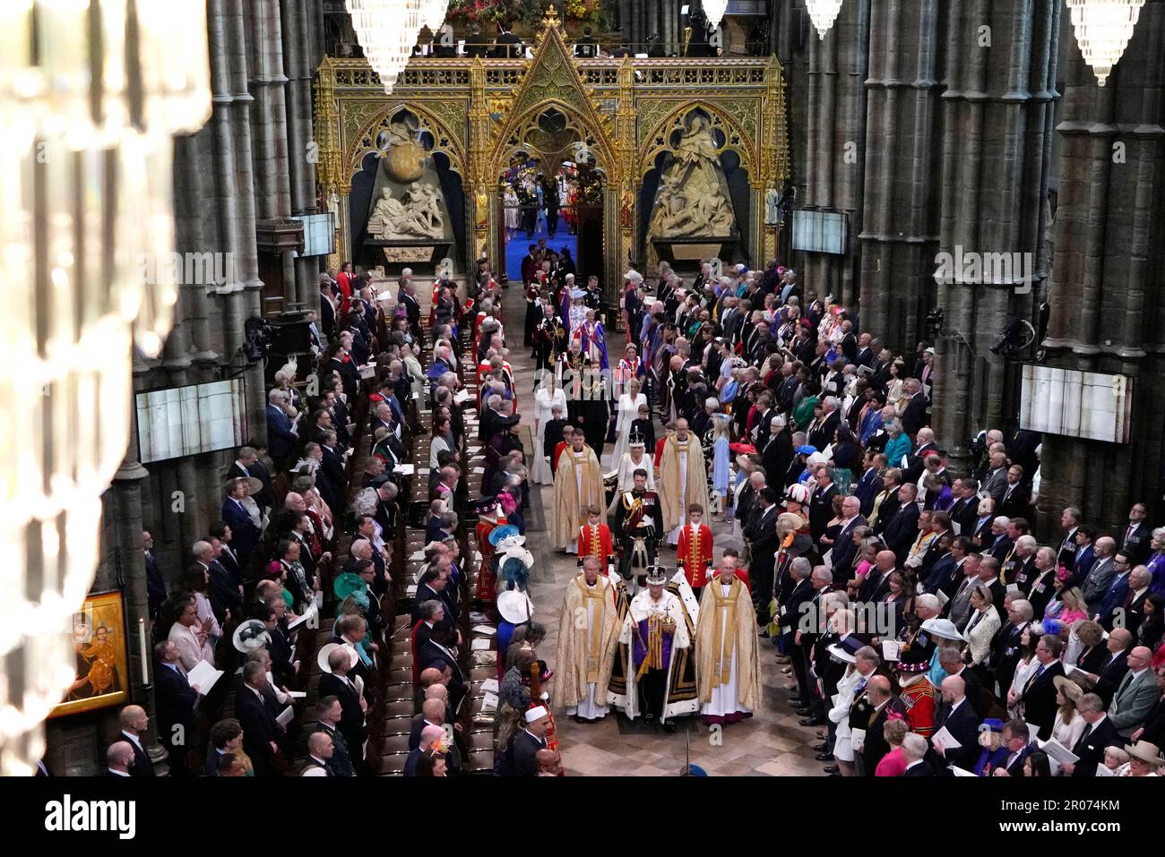 King Charles III, (front centre), followed by Queen Camilla, walk in ...