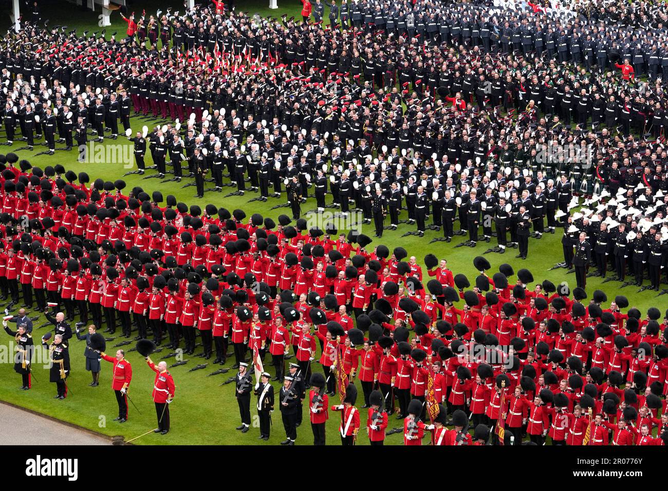 Members of the armed forces remove their headgear at Buckingham Palace ...