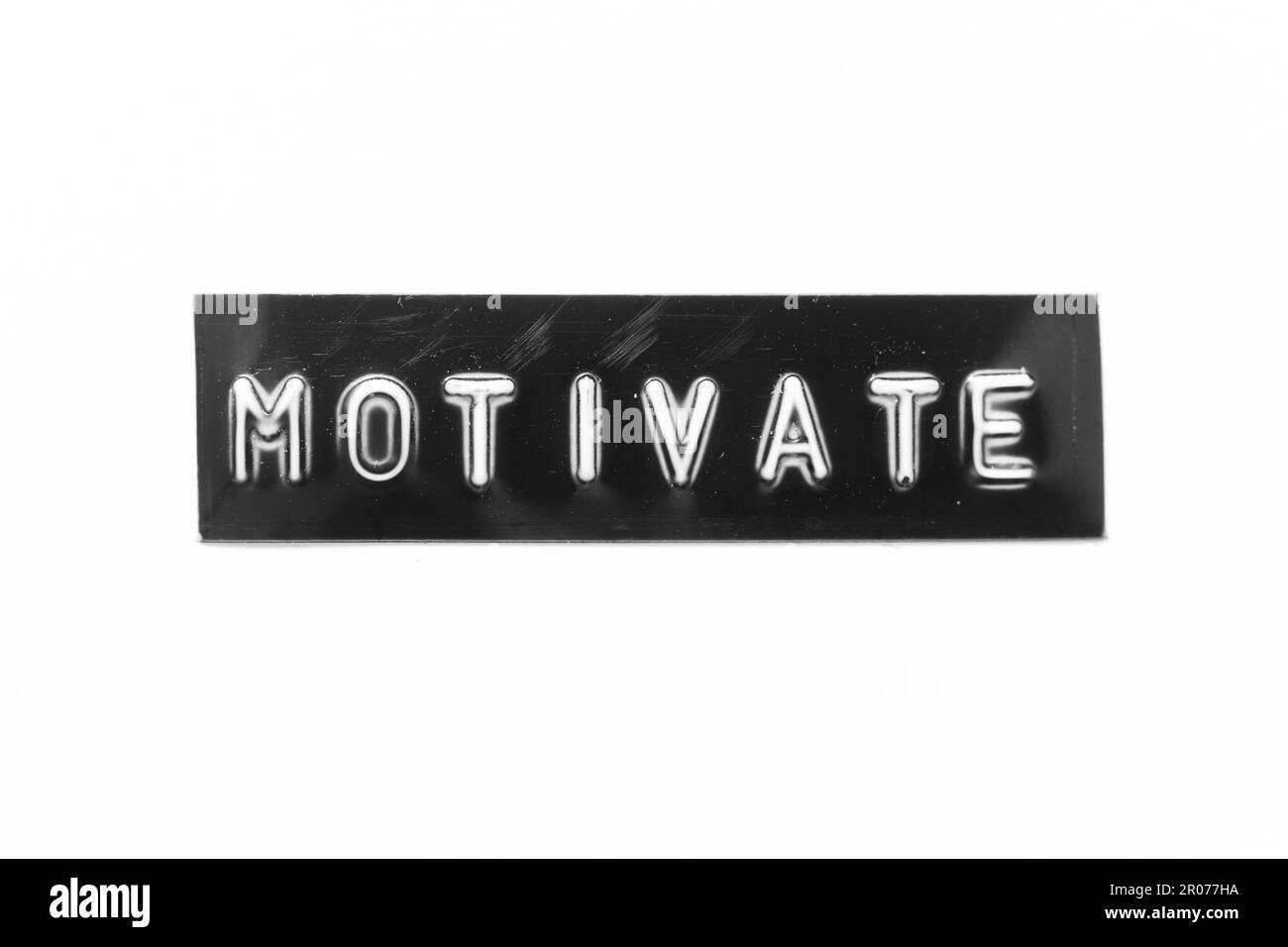 Black color banner that have embossed letter with word motivate on ...