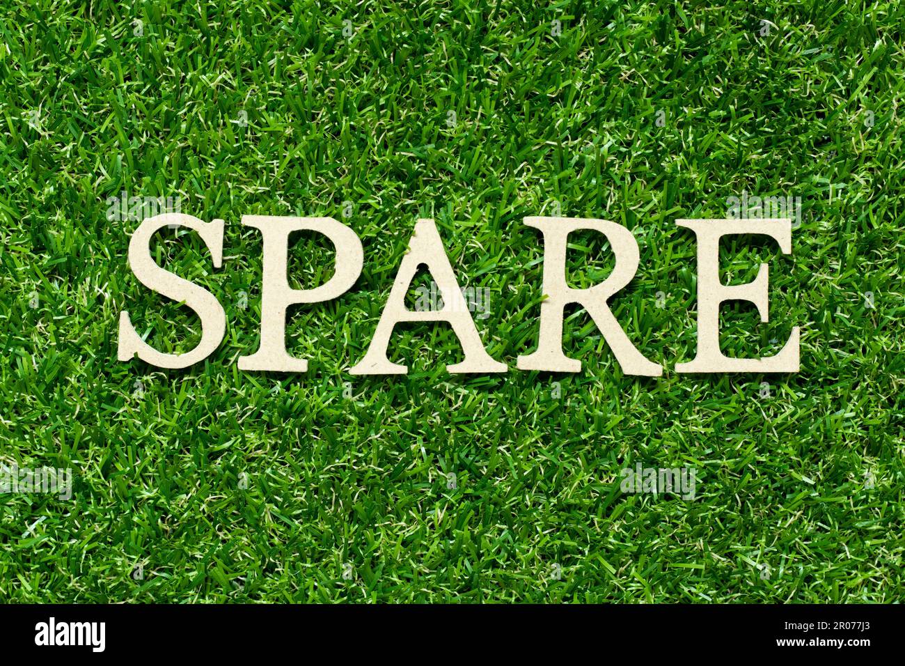 Wood letter in word spare on green grass background Stock Photo - Alamy